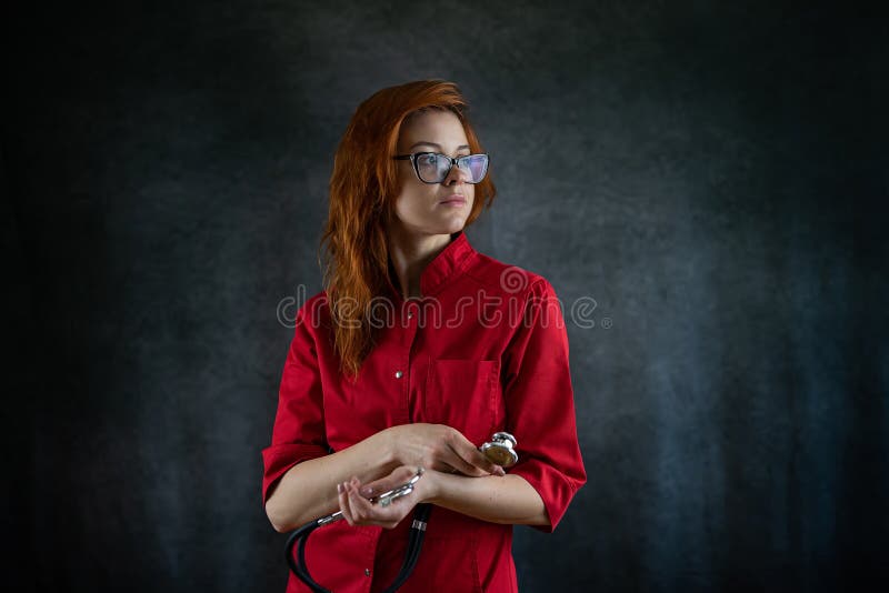 Portrait of Female Nurse or General Practitioner in Red Uniform with ...