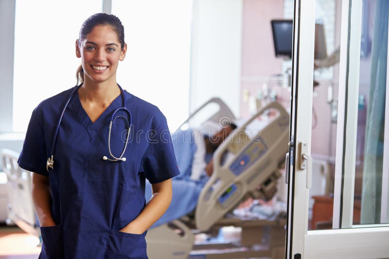 Portrait of Female Nurse with Patient in Background Stock Image - Image ...