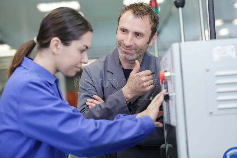 Female Operative Turning Switch on Machinery Controls Stock Photo ...