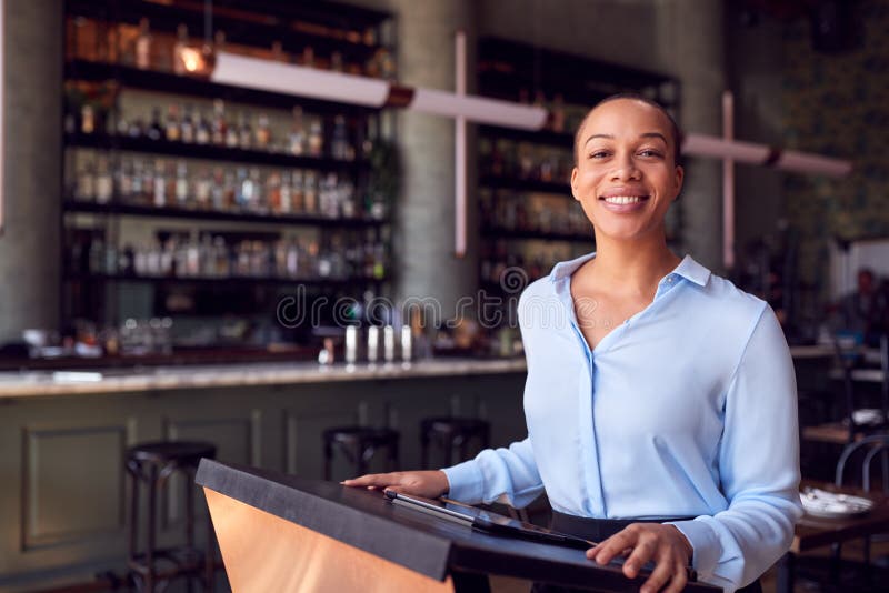 Portrait of Female Owner of Restaurant Bar Standing at Counter Using ...