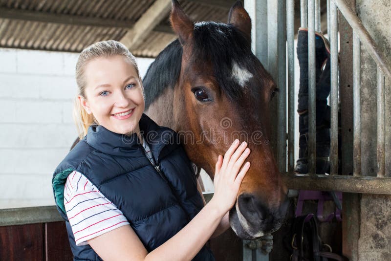 Portrait of Female Owner in Stable with Horse Stock Photo - Image of ...