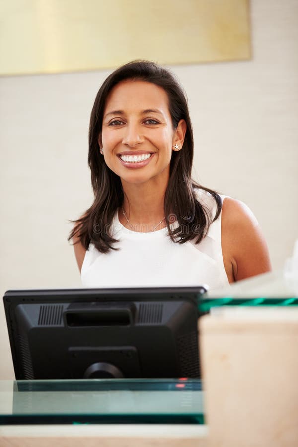 Portrait of Female Receptionist at Hotel Front Desk Stock Photo - Image ...