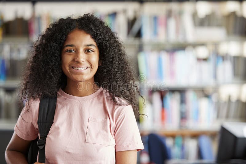Portrait of Female Student Standing in College Library Stock Photo ...