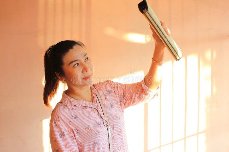 Portrait of Female Using Her Wallet To Cover Her Face from the Sunlight ...