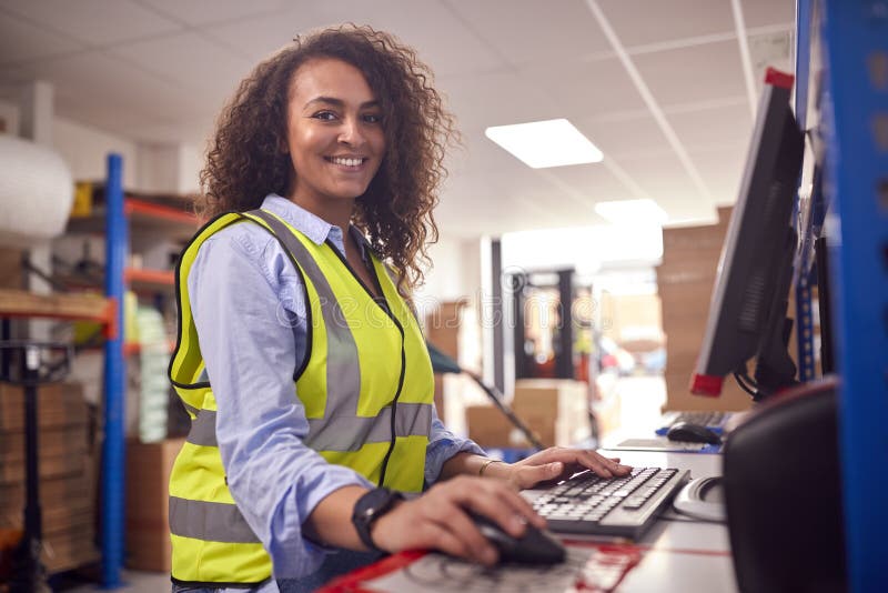 Portrait of Female Worker in Busy Modern Warehouse Working on Computer ...