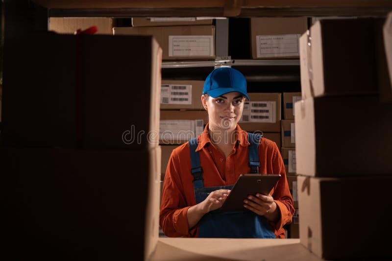Portrait of a Female Worker Checking Inventory Using Tablet Computer ...