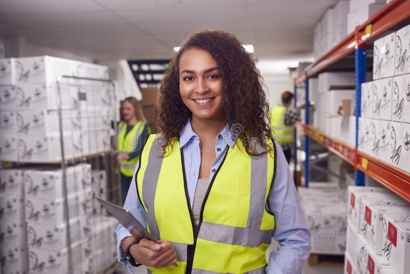 Portrait of Female Worker Inside Busy Warehouse Checking Stock on ...