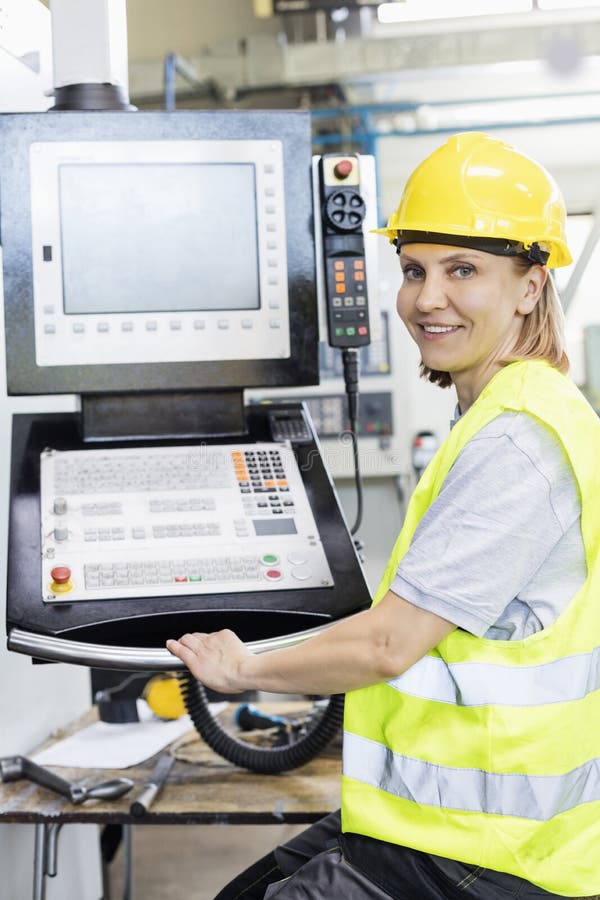 Portrait of Female Worker Operating Machinery at Control Panel in ...