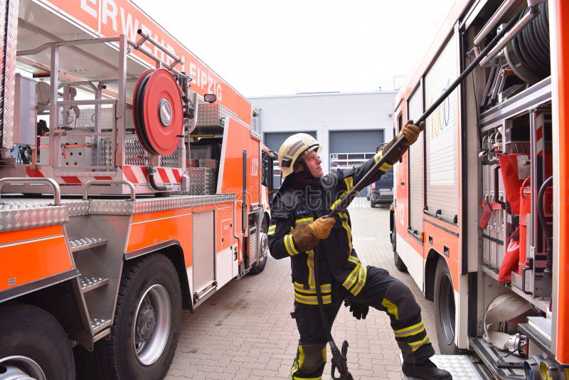 Portrait of a Firefighter at the Emergency Vehicle in the Fire Station ...