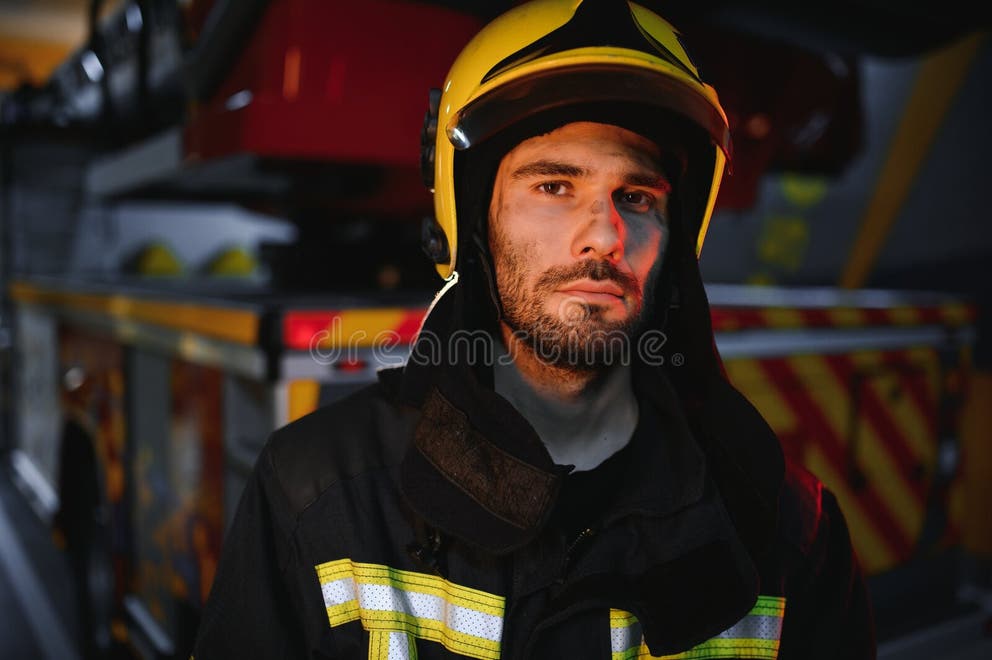 Portrait of a Firefighter in a Protective Suit and a Protective Helmet ...