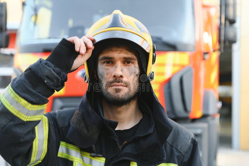 Portrait of a Firefighter in a Protective Suit and a Protective Helmet ...