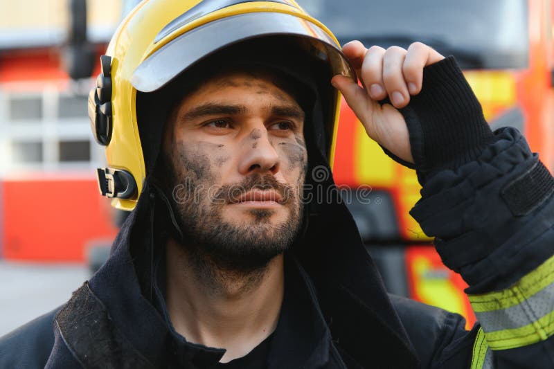 Portrait of a Firefighter in a Protective Suit and a Protective Helmet ...