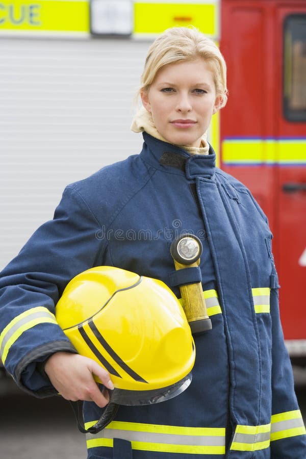 Fire Fighter Standing In Front Of Fire Engine Stock Image - Image of ...