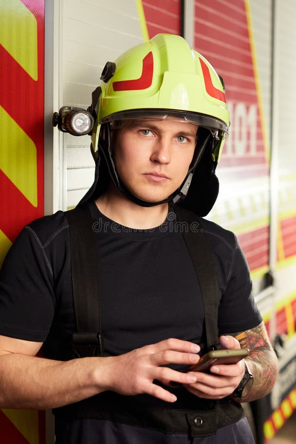 Portrait of a Firefighter Standing in Front of a Fire Engine. Fireman ...