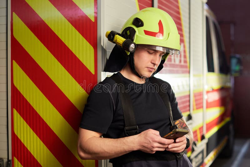 Portrait of a Firefighter Standing in Front of a Fire Engine. Fireman ...