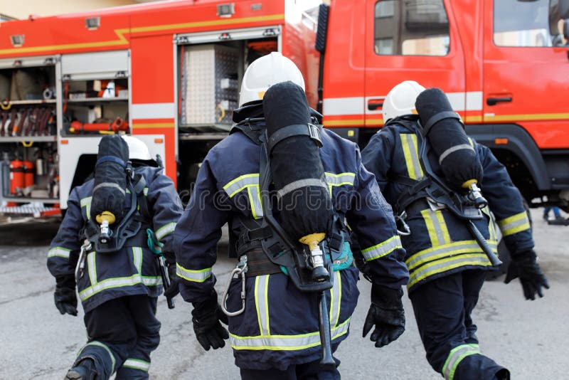 Portrait of a Firefighter Standing in Front of a Fire Engine. Fireman ...