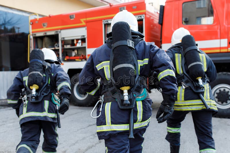 Portrait of Firefighter in Uniform in Front of Fire Engine Machine and ...