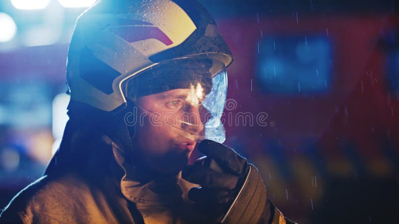 Portrait of the Fireman in Full Uniform during the Night Rain Stock ...