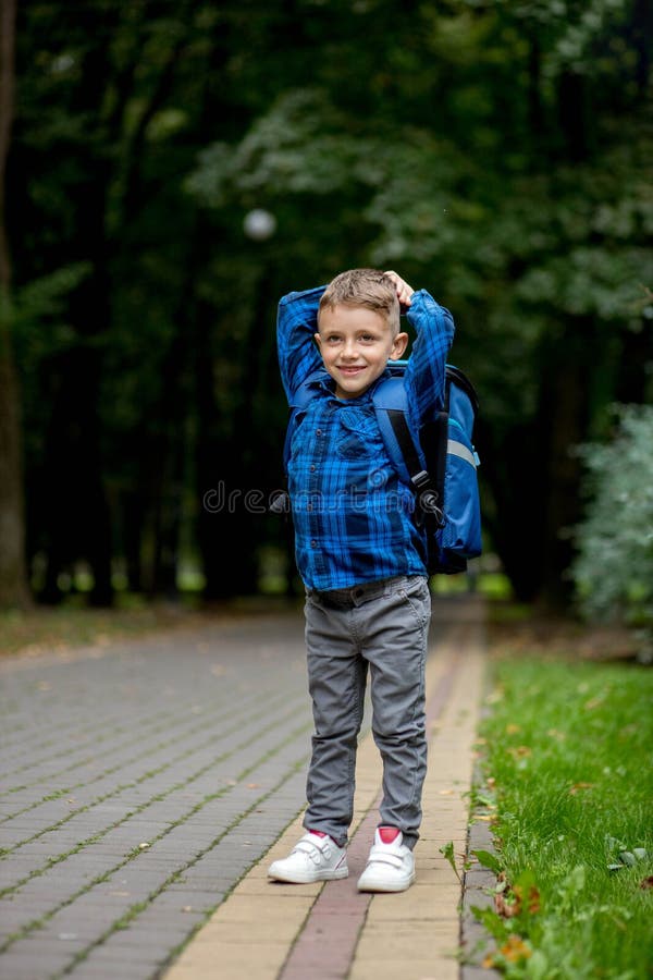 Portrait of a First Grader with a Backpack. the Boy Goes To School ...