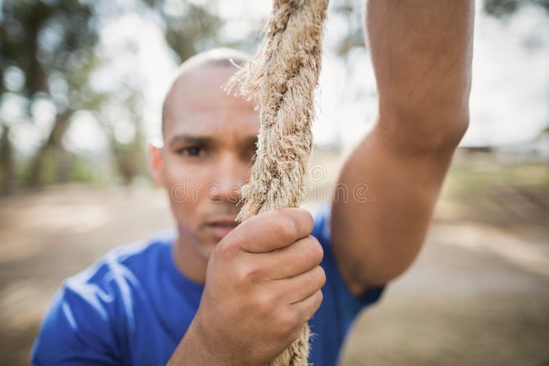 Portrait of Fit Man Climbing Rope during Obstacle Course Stock Image ...