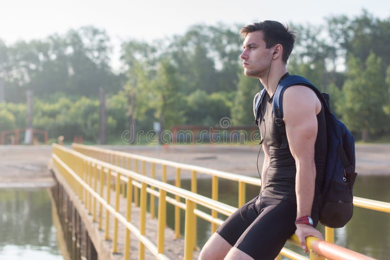 Portrait of Fit Man Runner Sitting and Resting Outdoors Near River ...