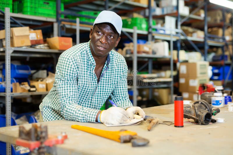 Portrait of Focused African-American Man Worker Checking Order List ...