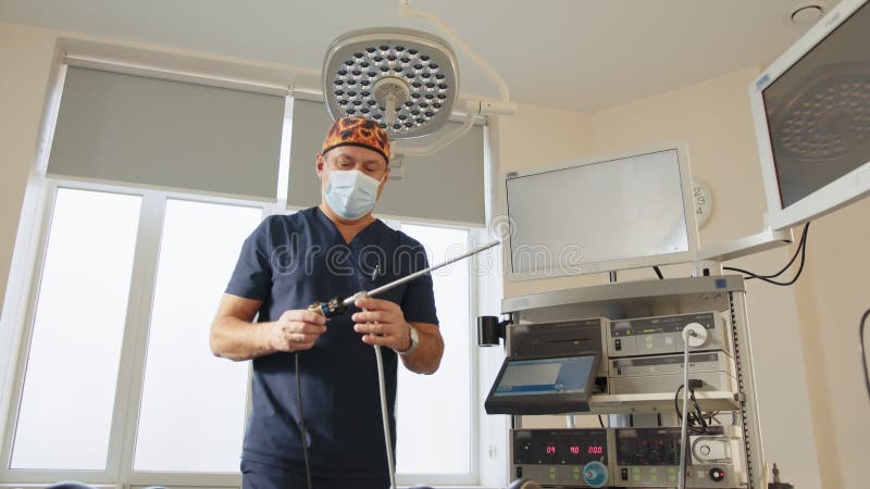 Portrait of a Focused Doctor Holding a Laparoscopic Instrument Looking ...