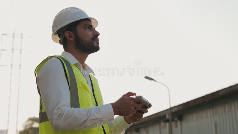 Portrait of Focused Engineer Flying Quadcopter with Remote at ...