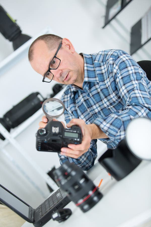 Portrait Focused Man Fixing Camera at Workplace Stock Image - Image of ...