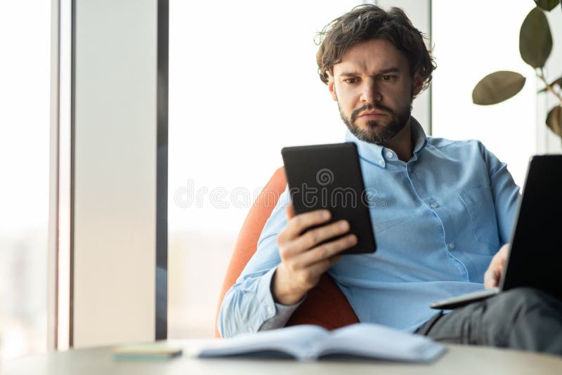 Portrait of Focused Man Using Digital Tablet and Pc Stock Photo - Image ...