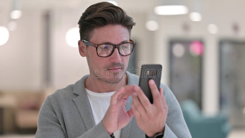 Portrait of Focused Middle Aged Man Using Smartphone Stock Image ...
