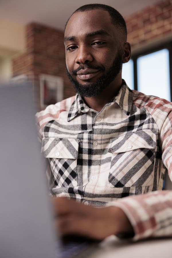 Portrait Of Focused Programmer Writting Code Typing On Laptop Keyboard Sitting At Desk Stock