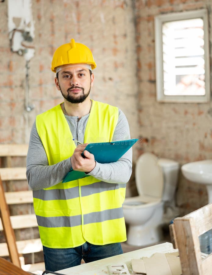 Builder Making Notes on Indoor Construction Site Stock Image - Image of ...