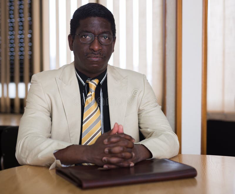 Portrait of Friendly Businessman at Negotiation Table in Office Stock ...