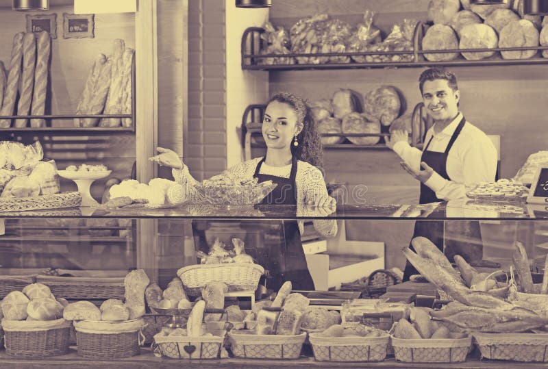 Portrait of Friendly Couple at Bakery Display with Pastry Stock Photo ...