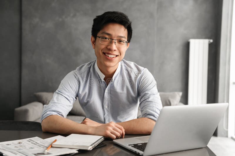 Portrait of a Friendly Young Asian Man Using Laptop Stock Image - Image ...