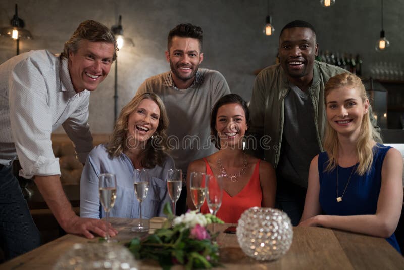 Portrait of Friends Sitting at Dining Table Stock Photo - Image of ...