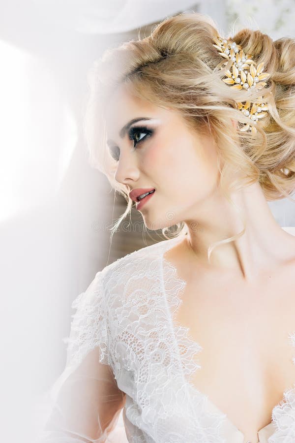 Portrait Of A Blond Girl In A Negligee With A Beautiful Hairdo A Stock