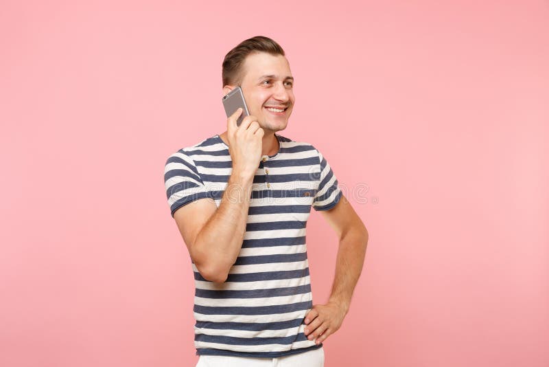 Portrait Of Fun Emotional Young Man Talking On Mobile Phone Conducting