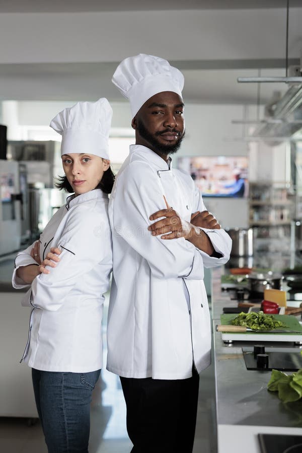 Portrait of Gastronomy Experts Standing Back To Back Inside Restaurant ...