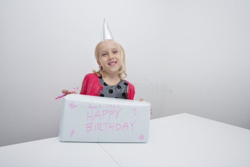 Portrait of Girl with Birthday Present at Table in House Stock Photo ...