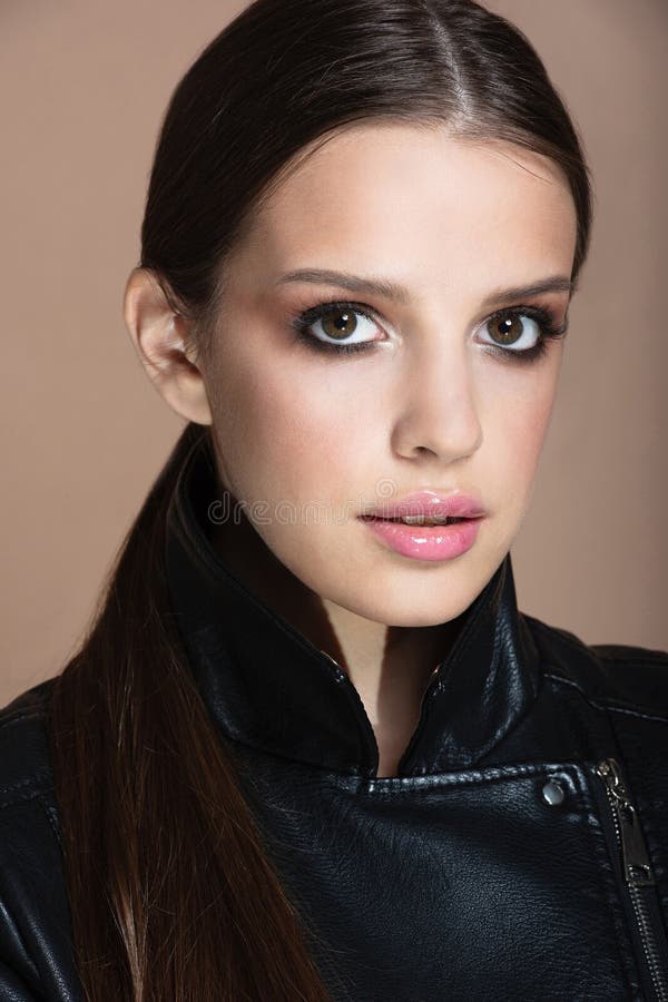 Portrait Of Girl With Brown Eyes And Brown Hair In Leather Jacket Stock
