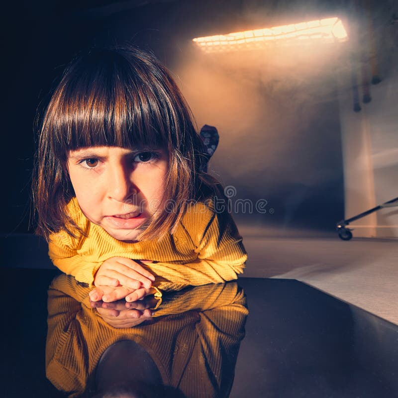 Portrait of a Girl, Lying on the Floor of a Photography Studio, with ...