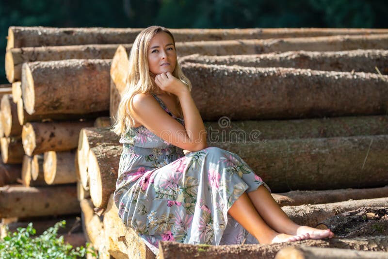 Portrait of a Girl Sitting on Logs Stock Image - Image of green, beauty ...
