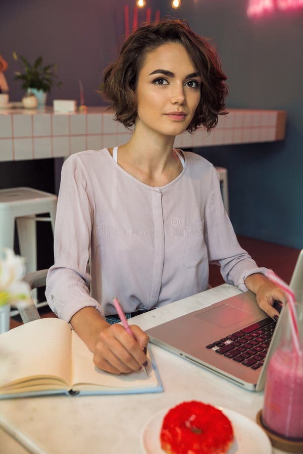Portrait of a Girl Typing on Laptop and Writing Notes Stock Photo ...