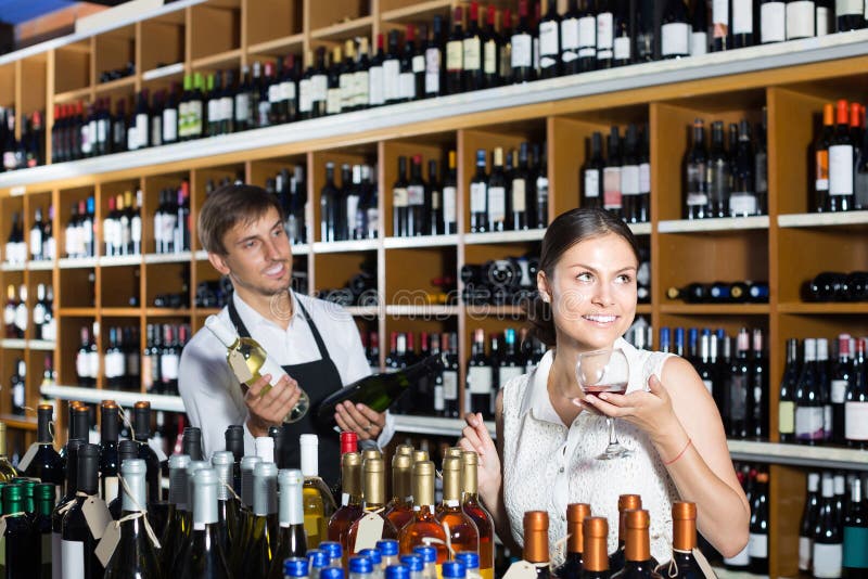 Portrait of Glad Female Customer Tasting Wine before Purchasing Stock ...