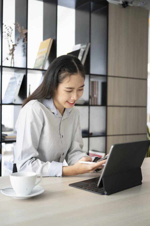 Happy Female Employee Smiling and Working on Computer Tablet at Modern ...