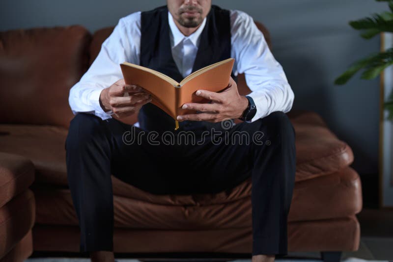 Portrait of a Good Looking Asian Man Sitting on the Sofa Reading a Book ...