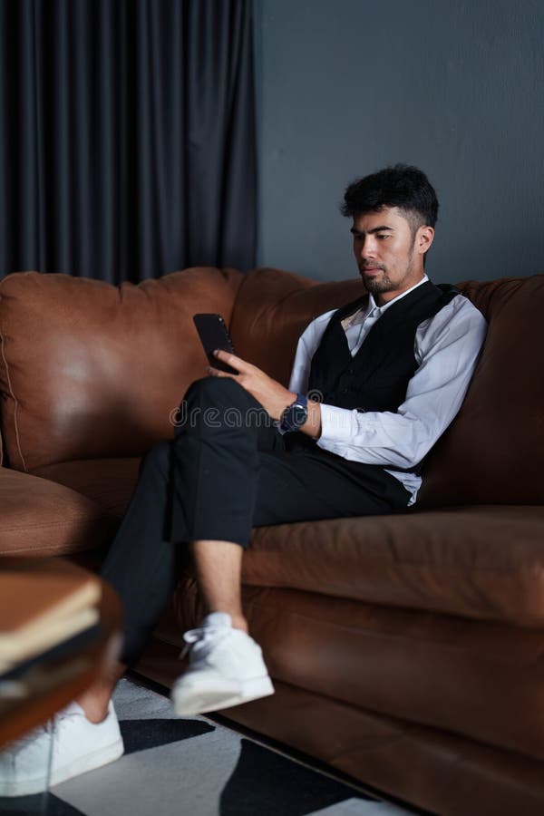 Portrait of a Good Looking and Discreet Asian Man Sitting on the Sofa ...