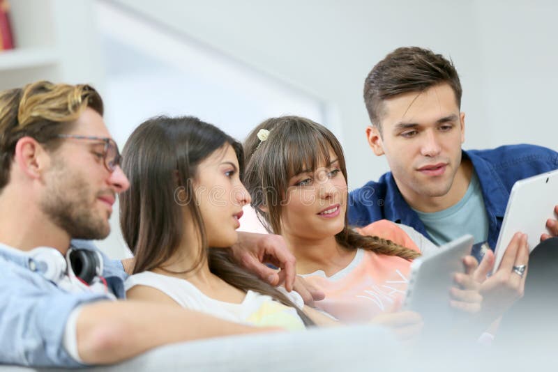 Portrait of Group of Friends on Sofa Using Tablets Stock Image - Image ...